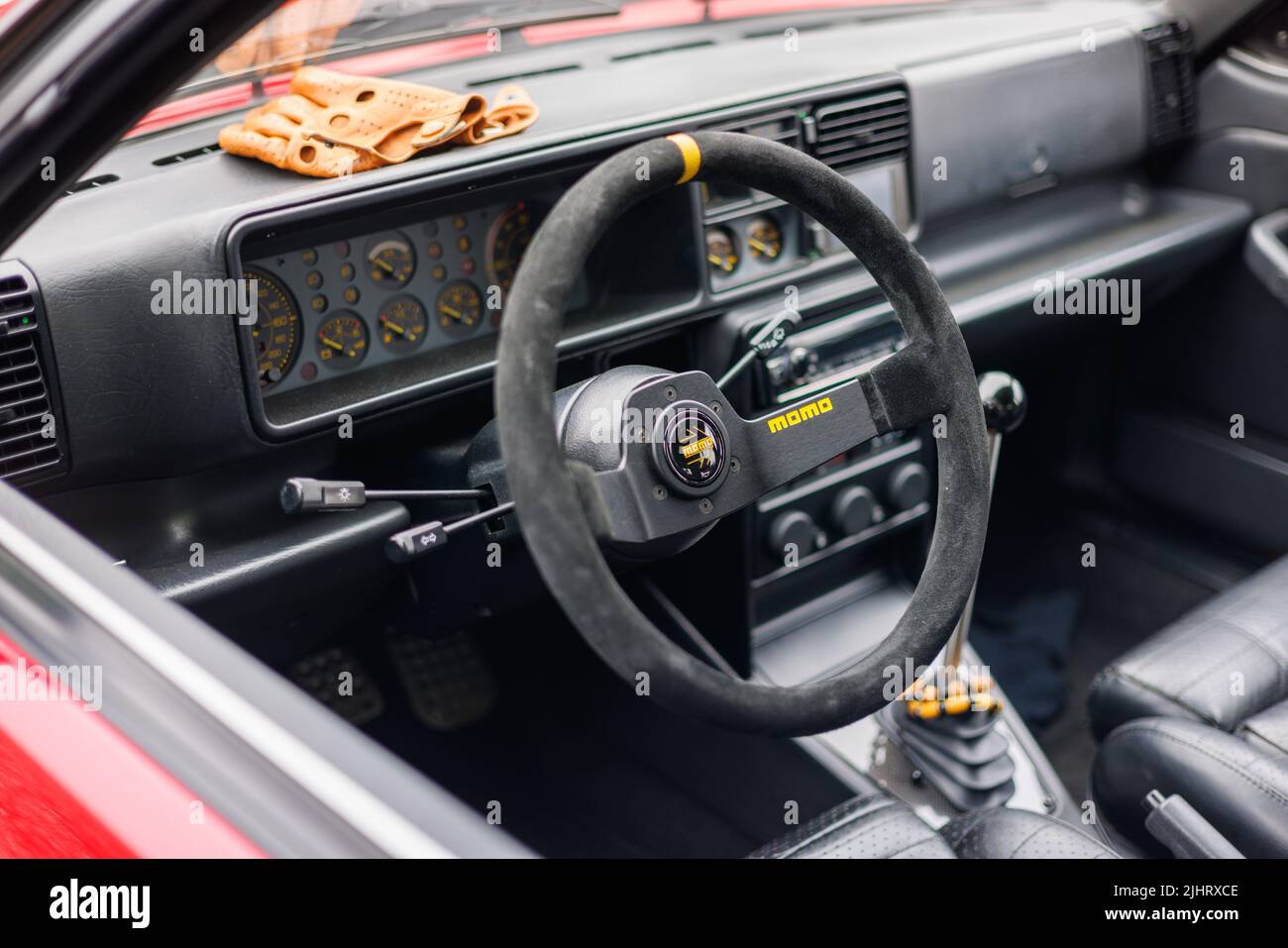A close-up of a Lancia Delta interiors with Momo steering wheel Stock Photo - Alamy