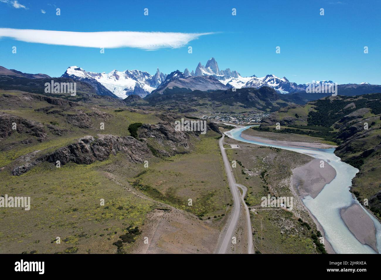 An aerial view of Fitz Roy mountain, with blue sky and river, Patagonia ...