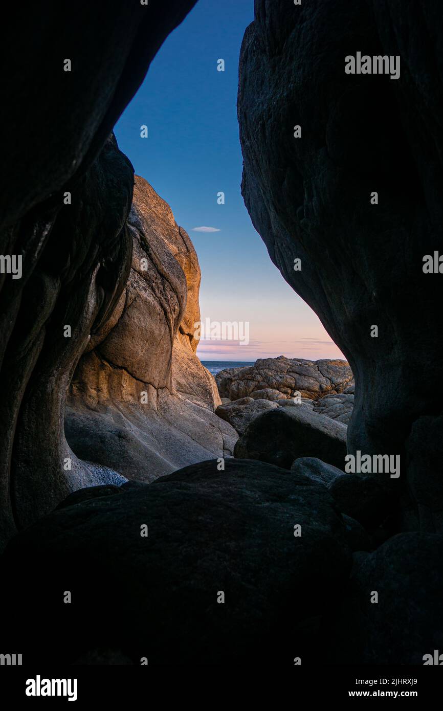 A landscape through big rocks Stock Photo - Alamy