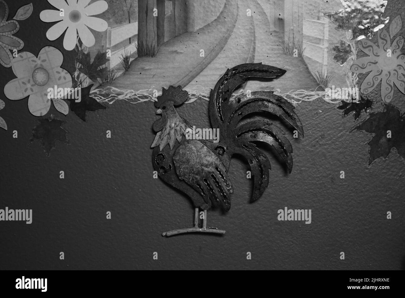 A grayscale of a rooster on a wall with beautiful painted flowers Stock ...