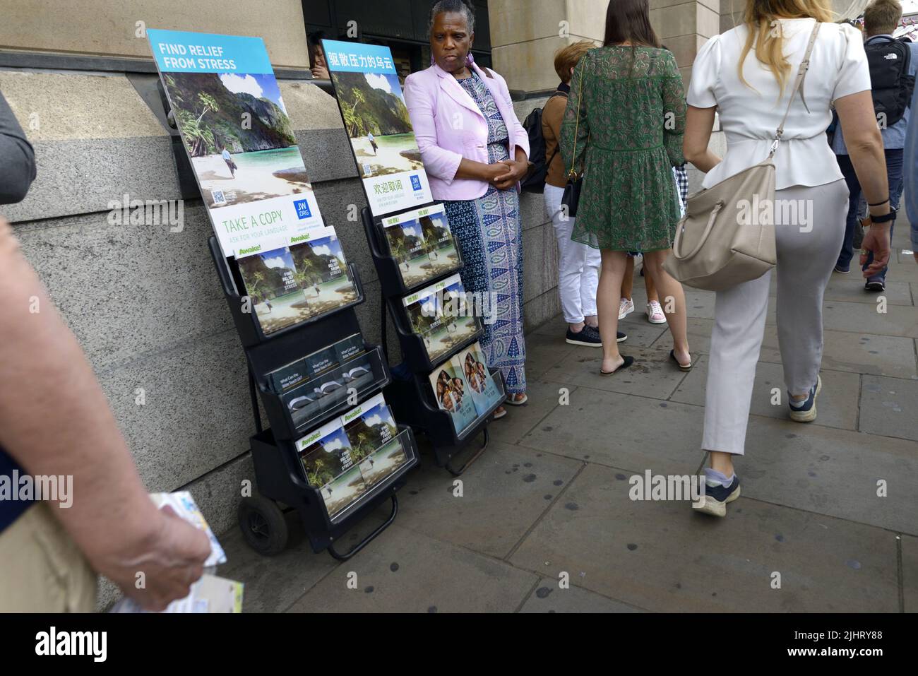 London, England, UK. Member of the Jehova's Witnesses giving away ...