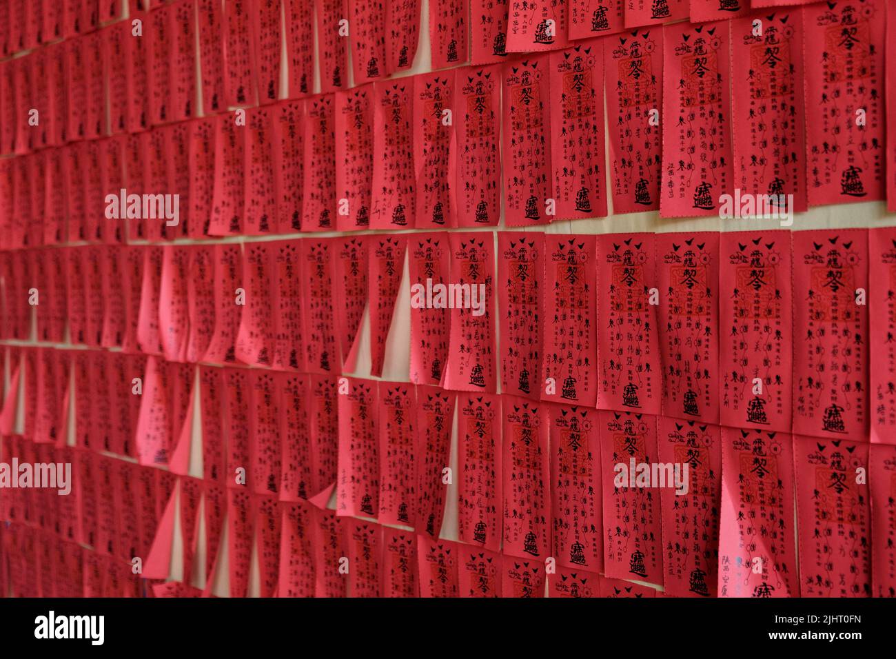 A wall pasted with red charms of Chinese god of wealth in five ...