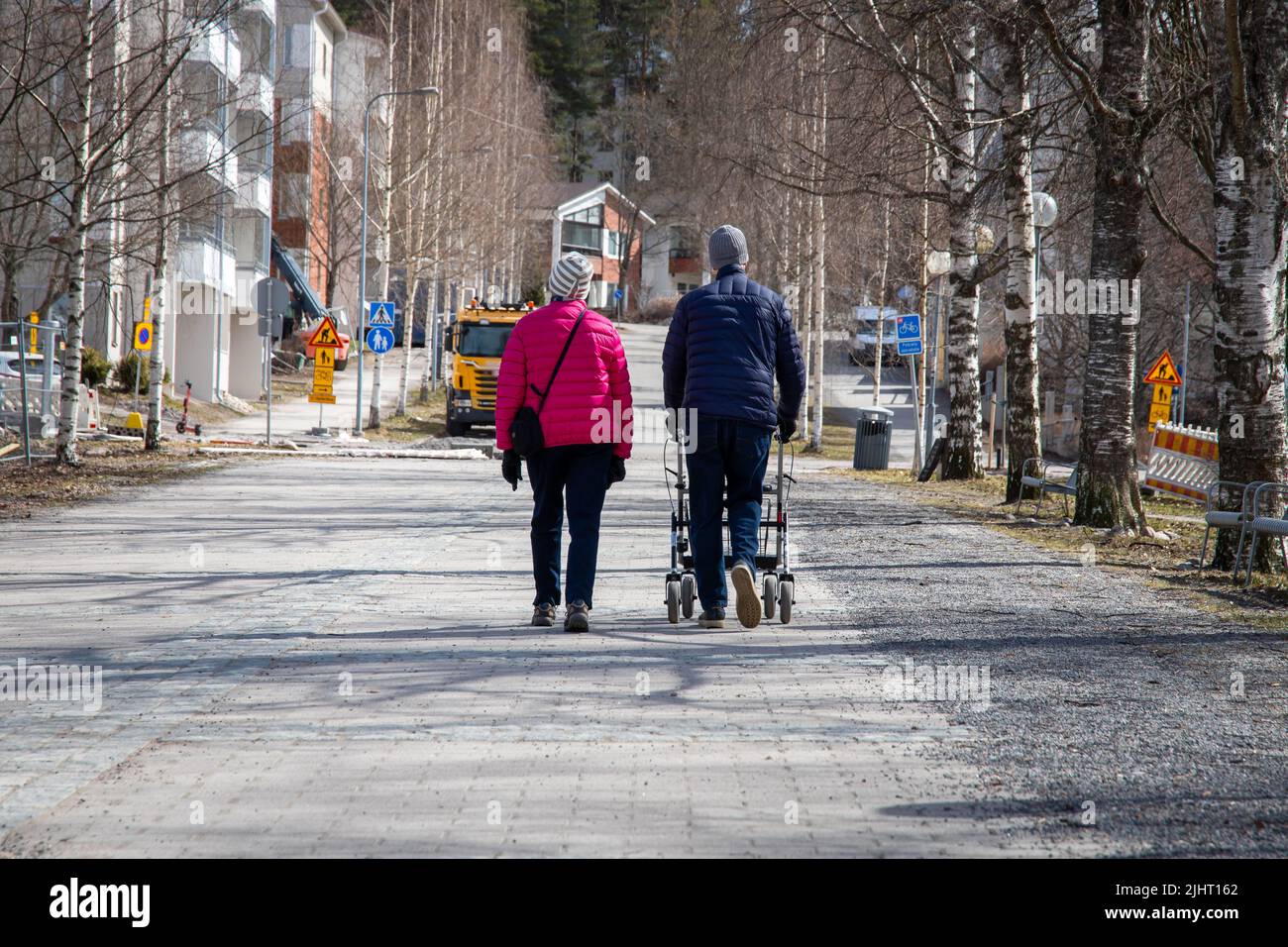 A young family from behind walking on the outside with a buggy Stock ...