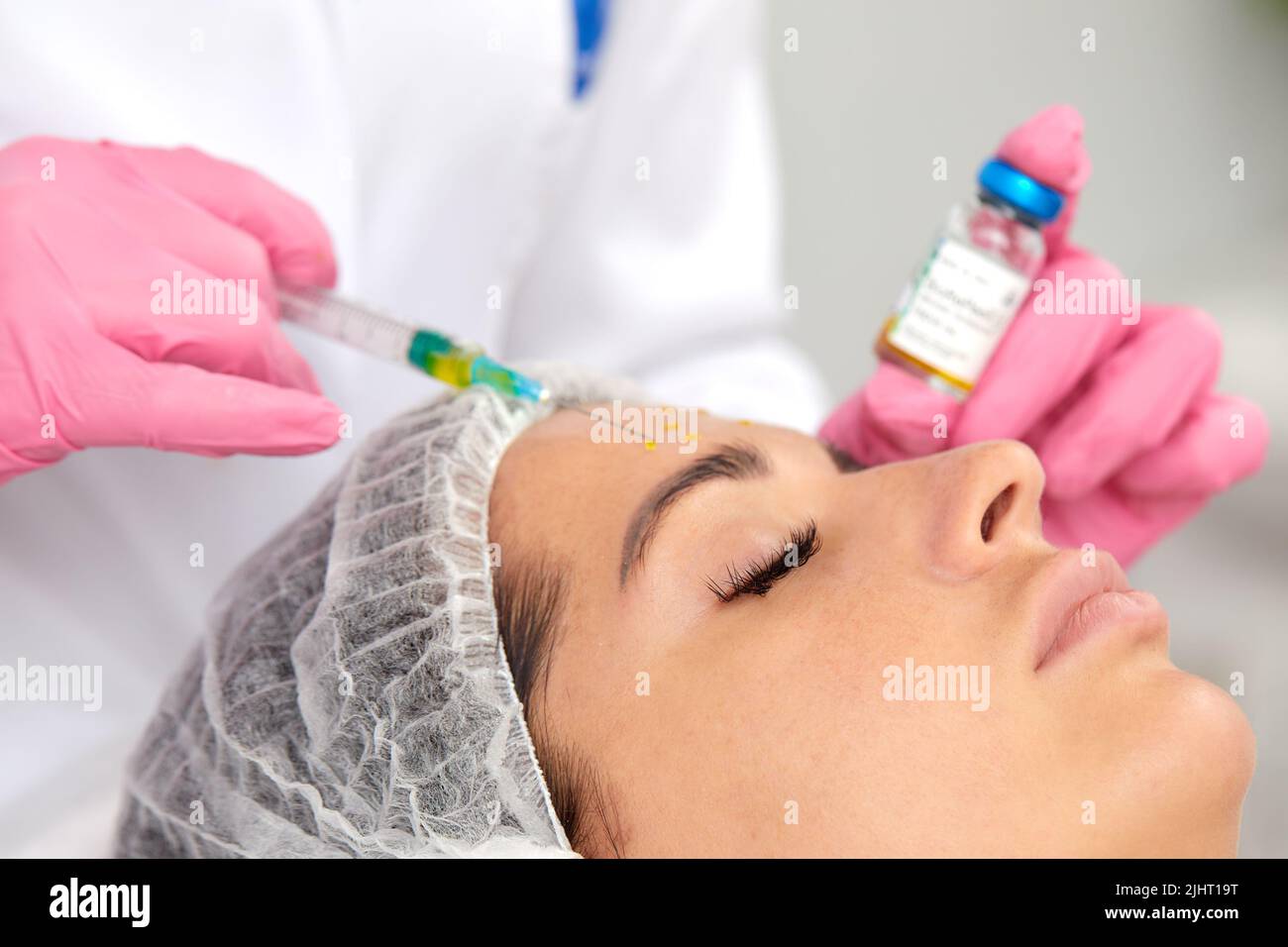 Portrait of young Caucasian woman getting botox cosmetic injection in ...