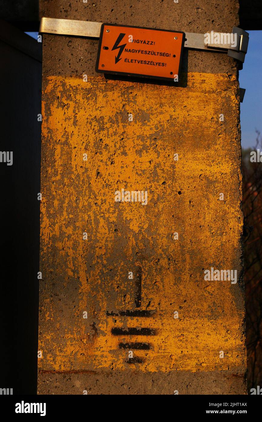 A vertical shot of a danger sign on the rusty wall Stock Photo - Alamy