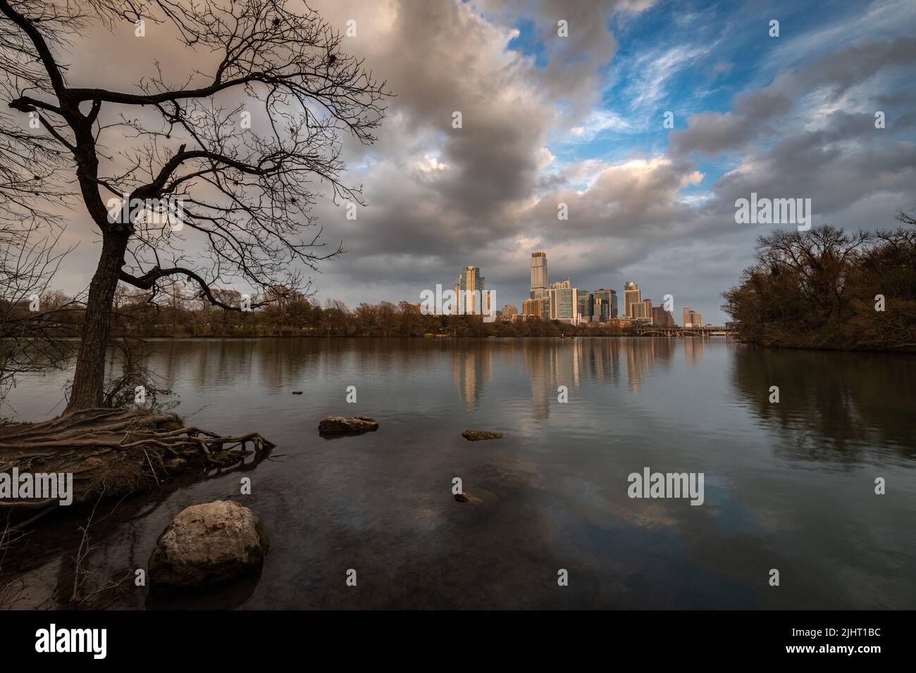 A panoramic view of trees with a lake and the Austin, Texas skyline ...