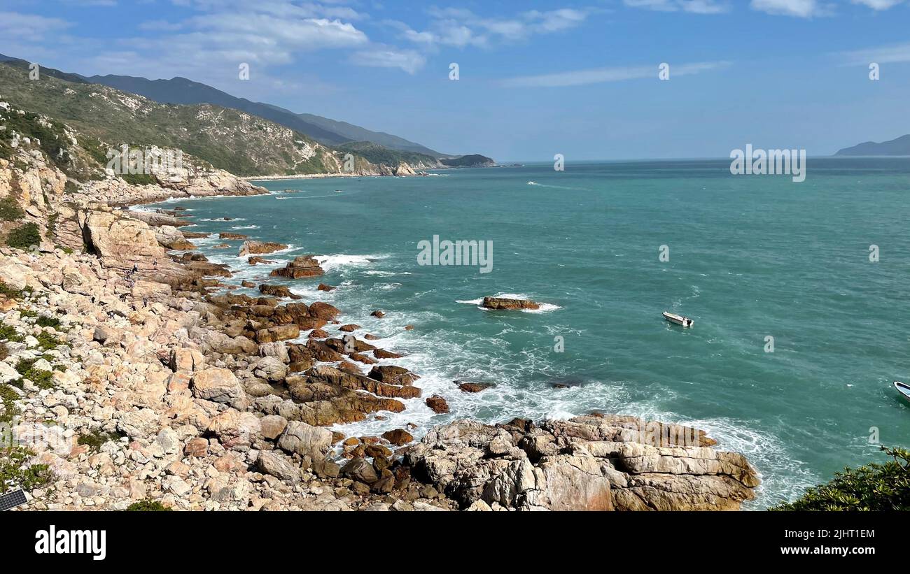A scenic view of Cheung Chau Island's coastal landscape with rocks and ...