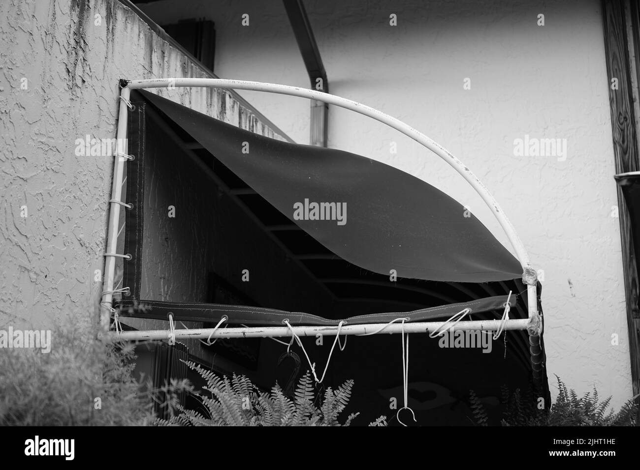 A low angle grayscale of a canopy against a wall outdoors Stock Photo ...