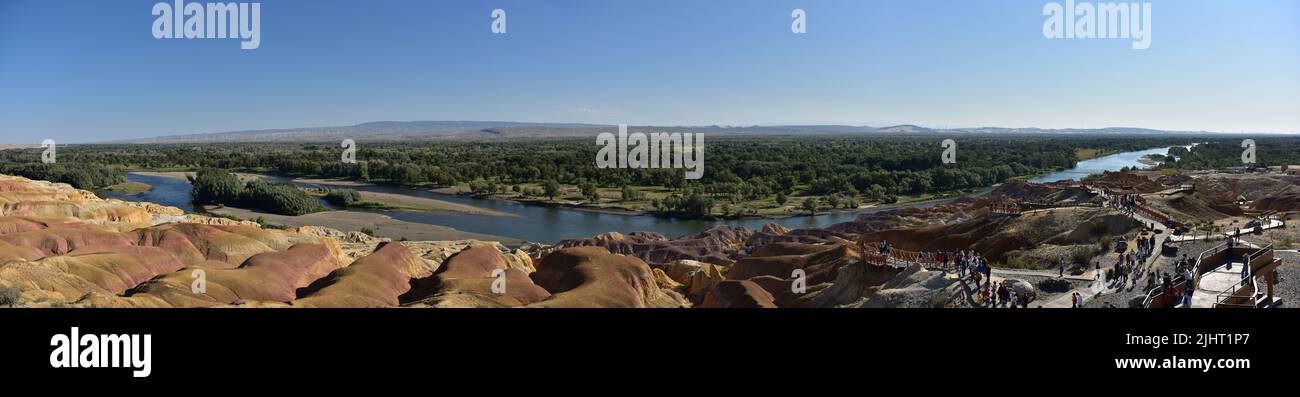 The panorama of a river splitting the forest and cliffs on a bright ...