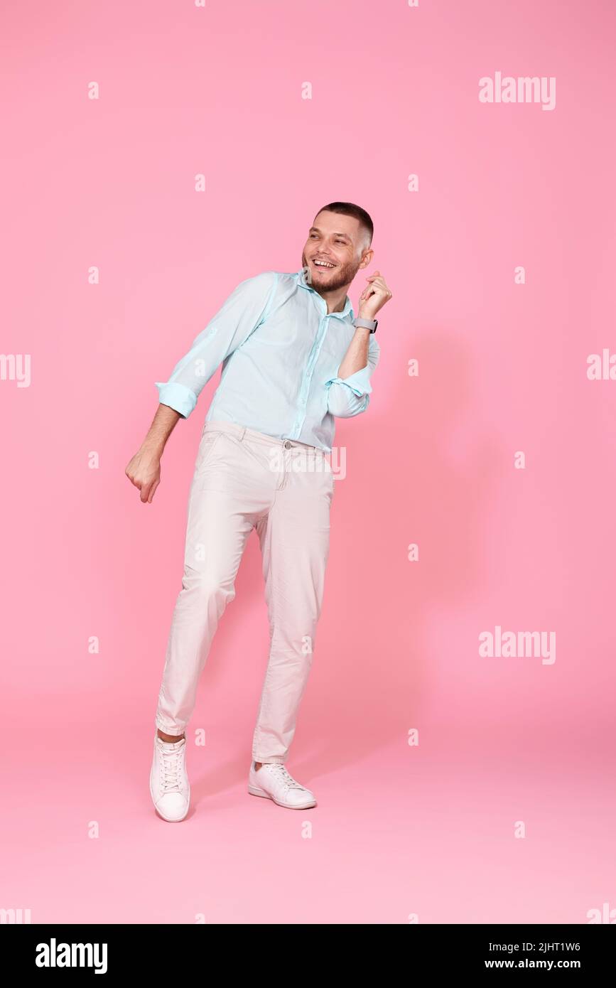 handsome smiling man in blue shirt dancing Stock Photo - Alamy