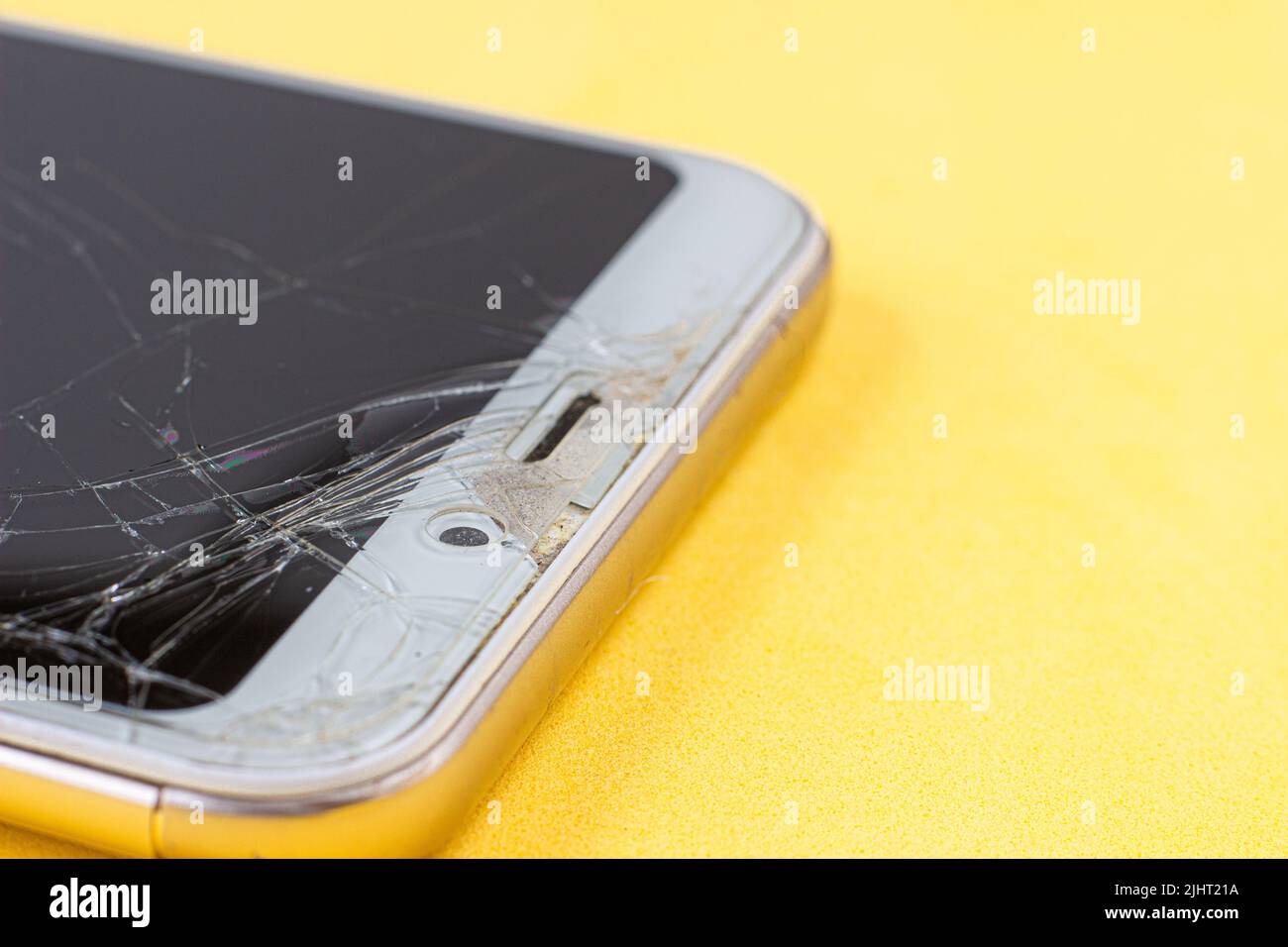 A closeup of a broken screen of a modern smartphone with numerous ...