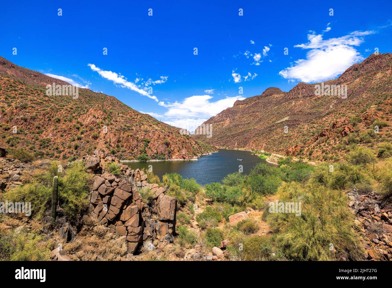 A boat floats in the Apache Lake reservoir, located in Central Arizona ...