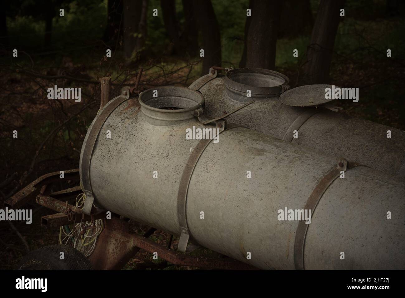 A close-up of old rusty water tanks in the forest Stock Photo - Alamy