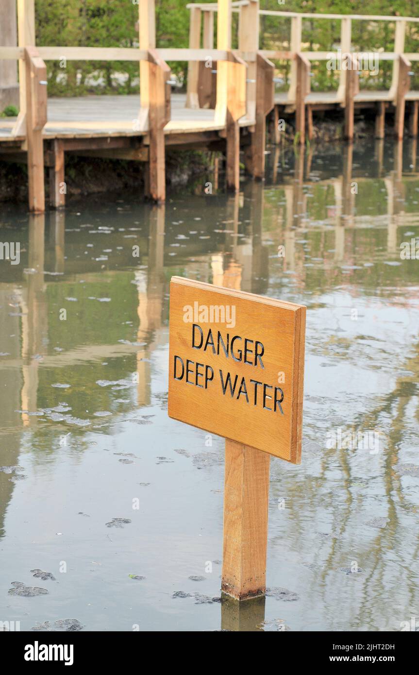 Wooden DANGER DEEP WATER sign in middle of lake Stock Photo - Alamy