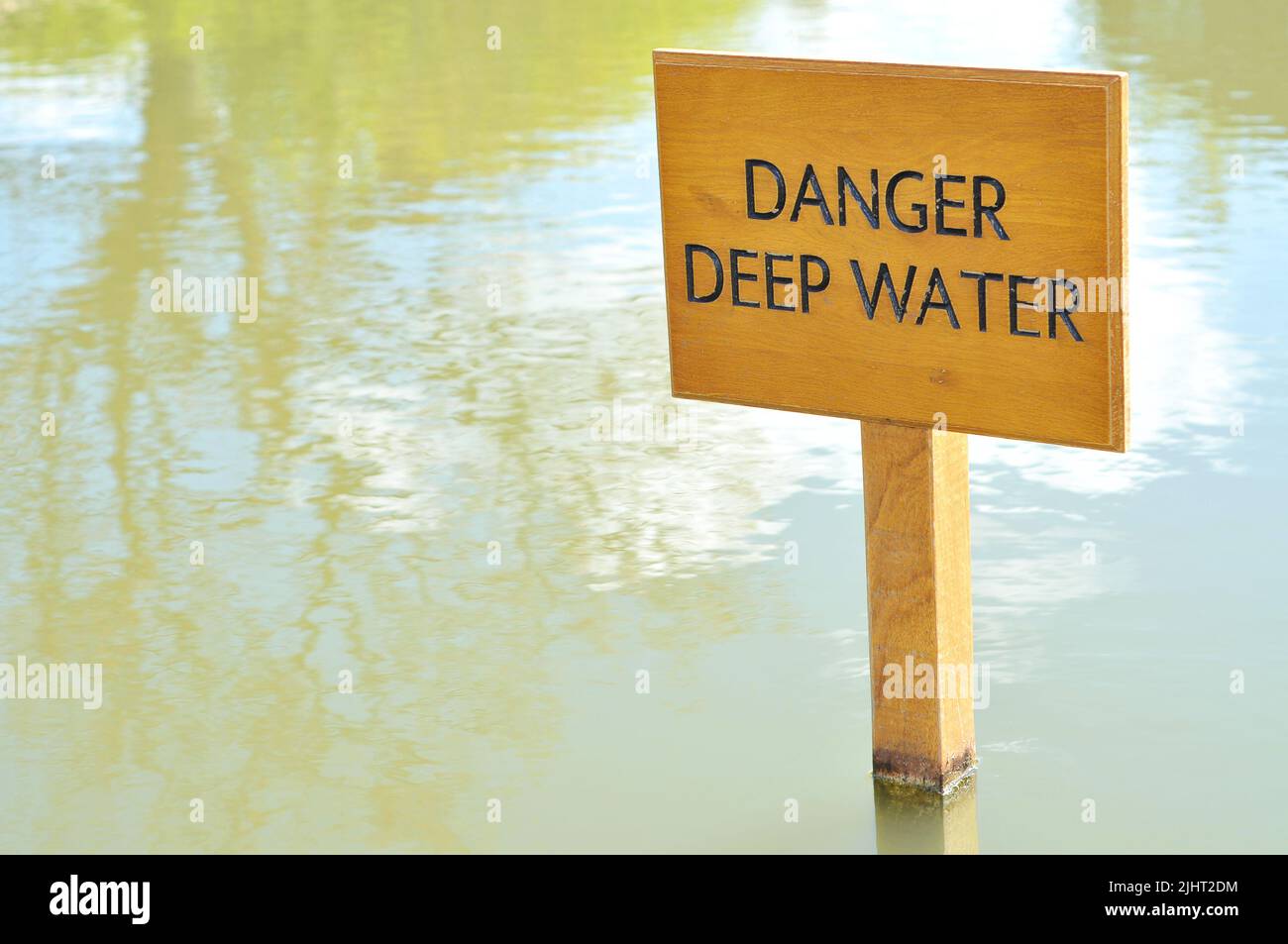 Wooden DANGER DEEP WATER sign in middle of lake Stock Photo - Alamy
