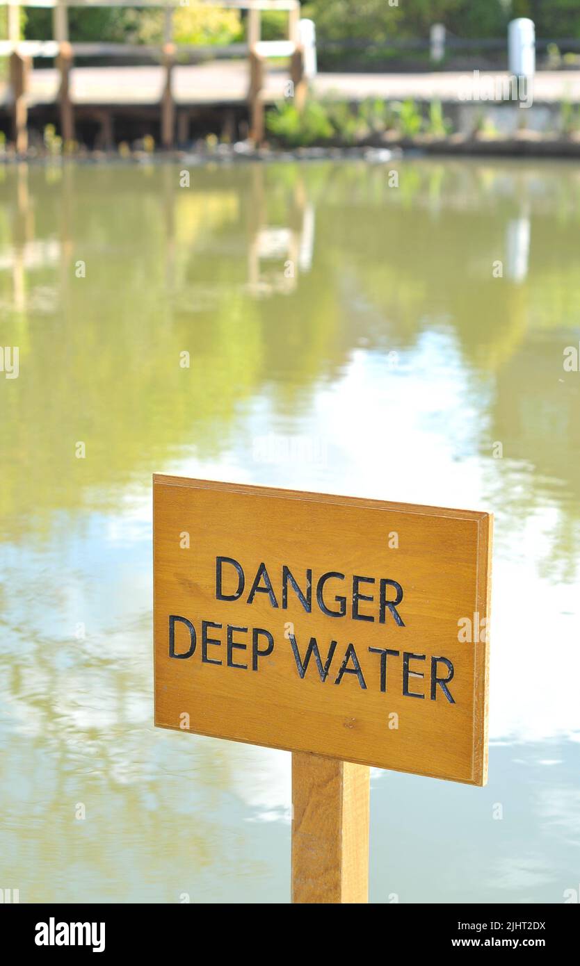 Wooden DANGER DEEP WATER sign in middle of lake Stock Photo - Alamy