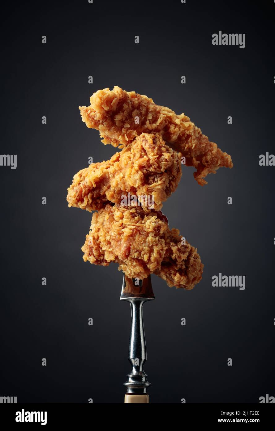 Delicious hot crispy fried chicken on a fork Stock Photo - Alamy