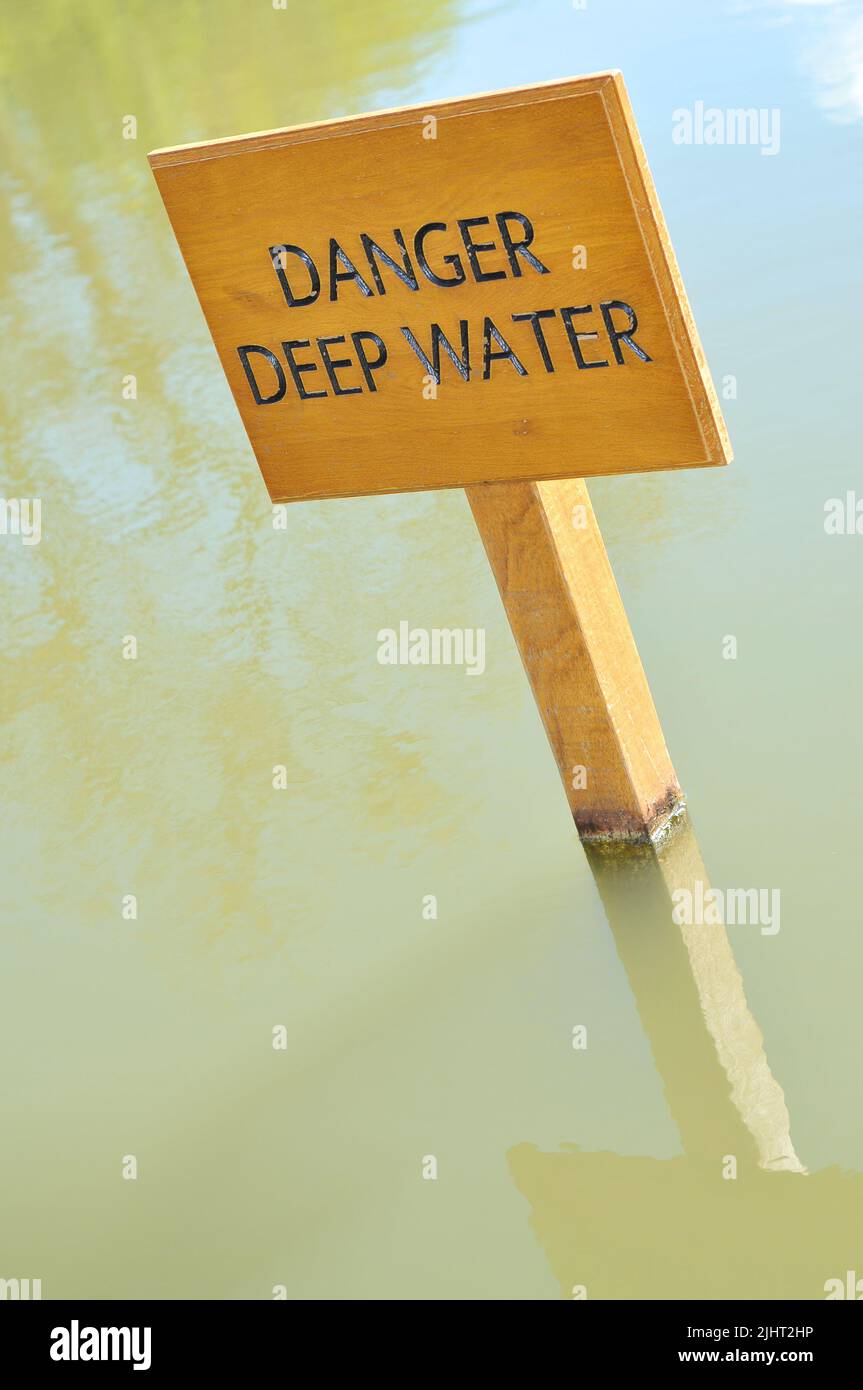 Wooden DANGER DEEP WATER sign in middle of lake Stock Photo - Alamy