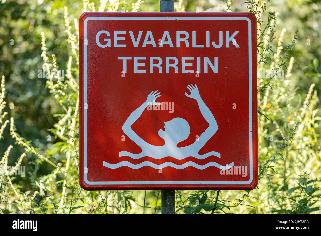 Red square signpost warning for hazardous situation behind. TRANSLATION ...