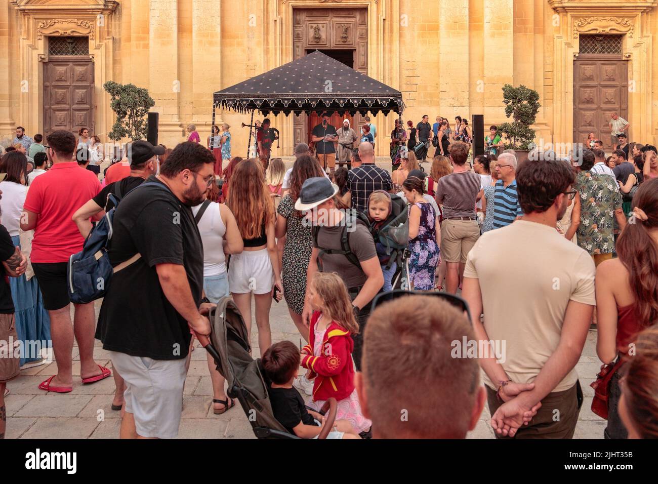 Spectators of a performance of medieval themed readings, poetry, music ...