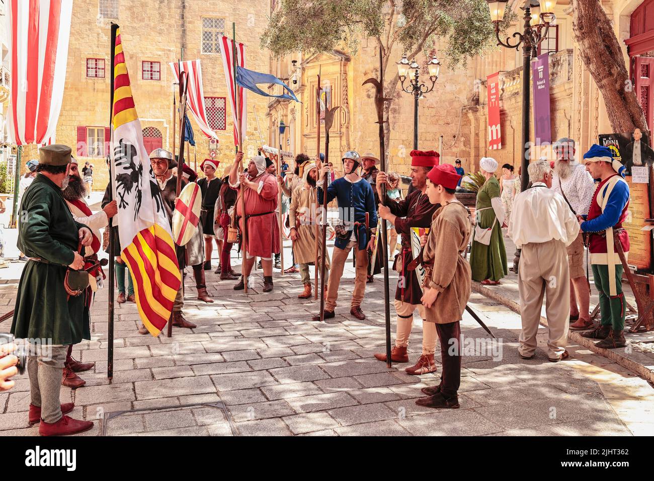 Performers dressed as men-at-arms or common foot-soldiers, holding ...