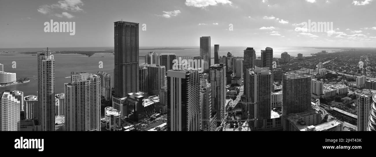 A grayscale panoramic shot of commercial buildings and skyscrapers of a ...