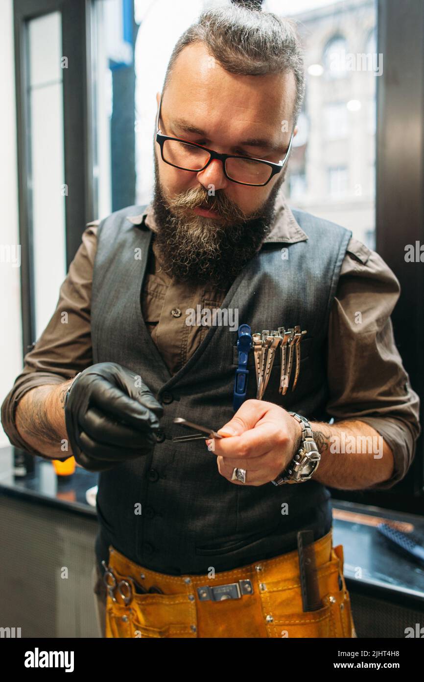 Professional barber check scissors before work Stock Photo - Alamy