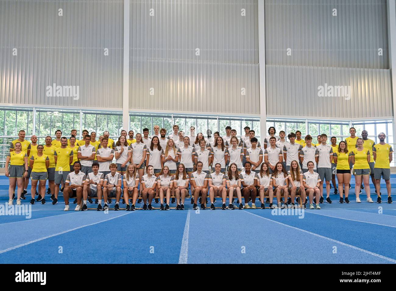 Athletes and staff pose for a family photo at a team building exercise ...