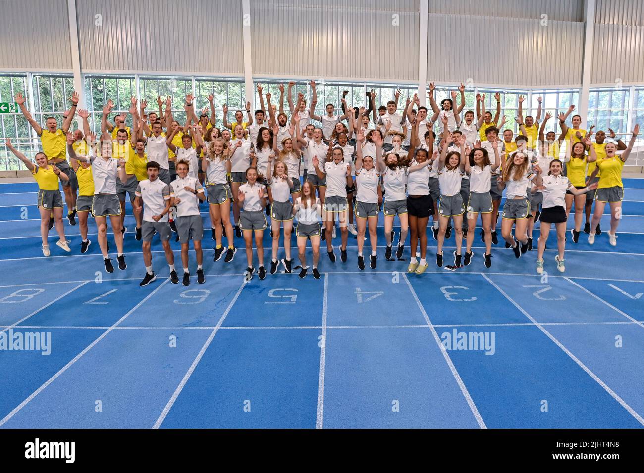 Athletes and staff pose for a family photo at a team building exercise ...