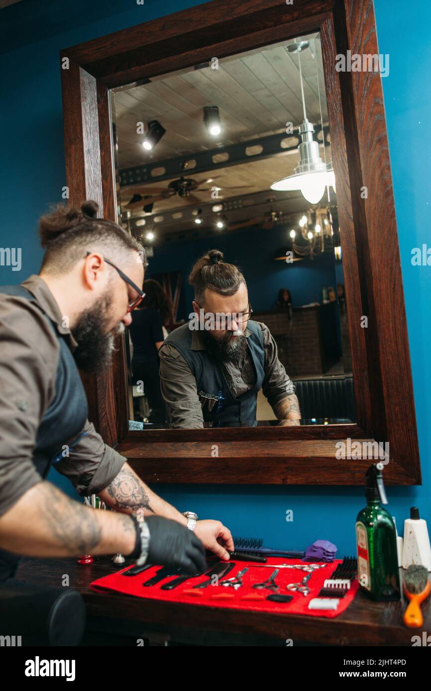 Barber preparing instruments for work free space Stock Photo - Alamy