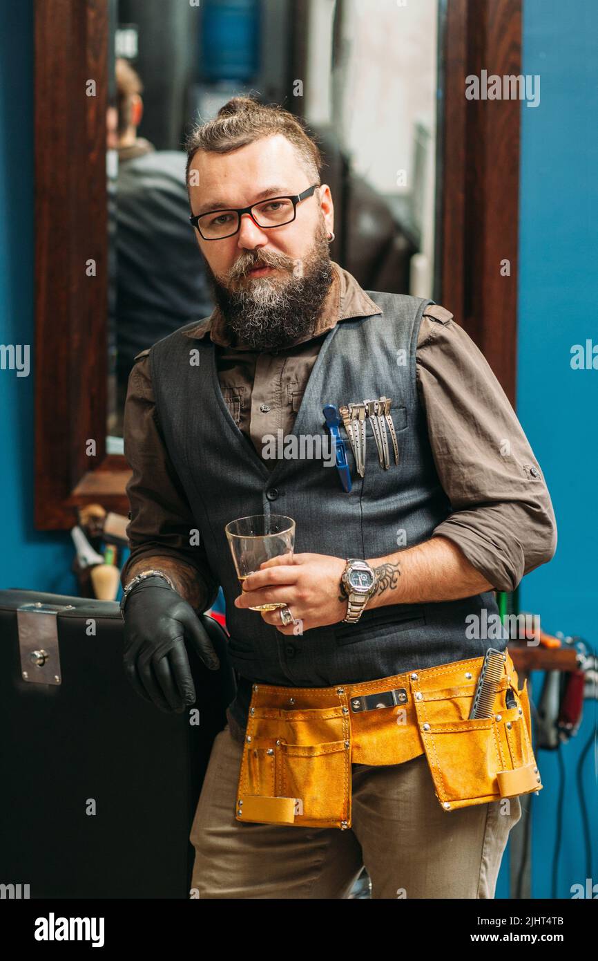 Tired barber relaxing after hard work day Stock Photo - Alamy