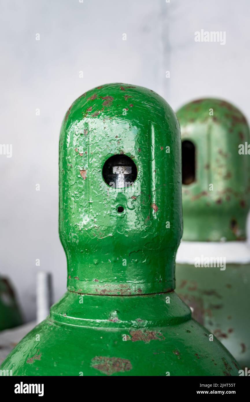 Compressed gas cylinders being stored vertically secured by a metal ...