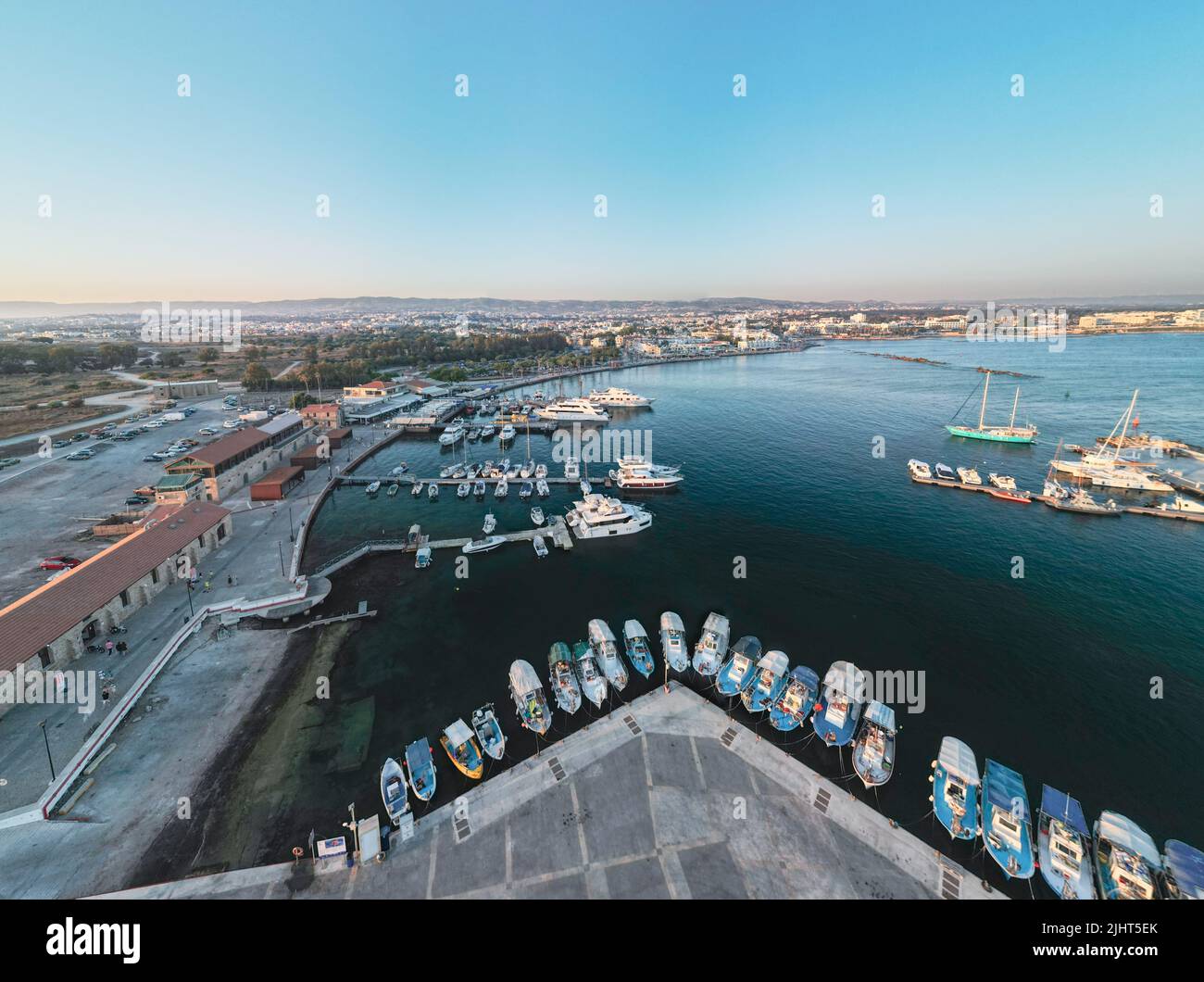 An aerial view of boats and ships at the harbor against blue sunset sky ...