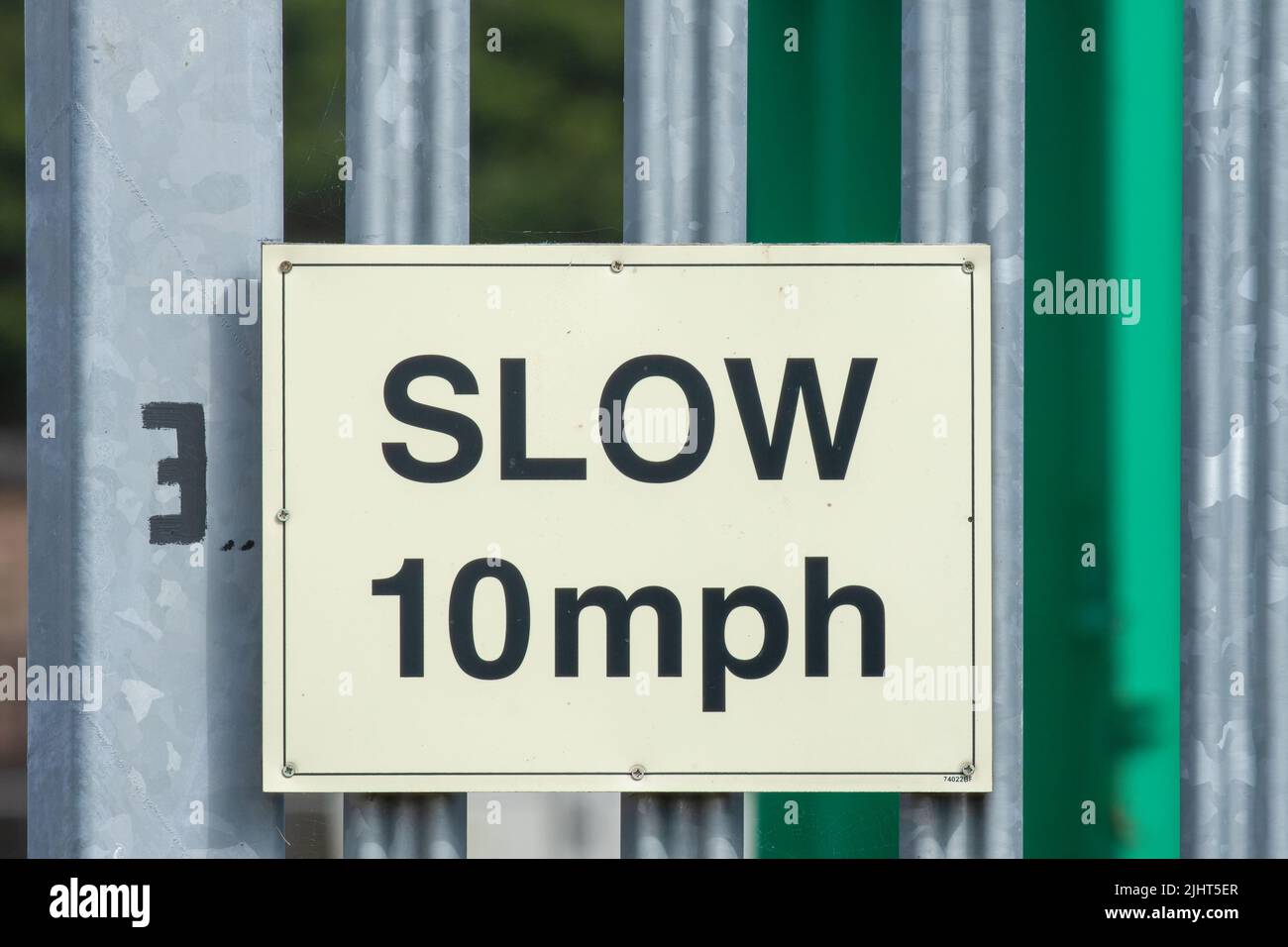 A closeup of a slow 10 mph sign on a metal gate Stock Photo - Alamy