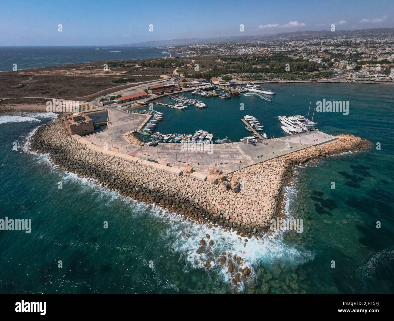An aerial view of boats and ships at the harbor against blue sunset sky ...
