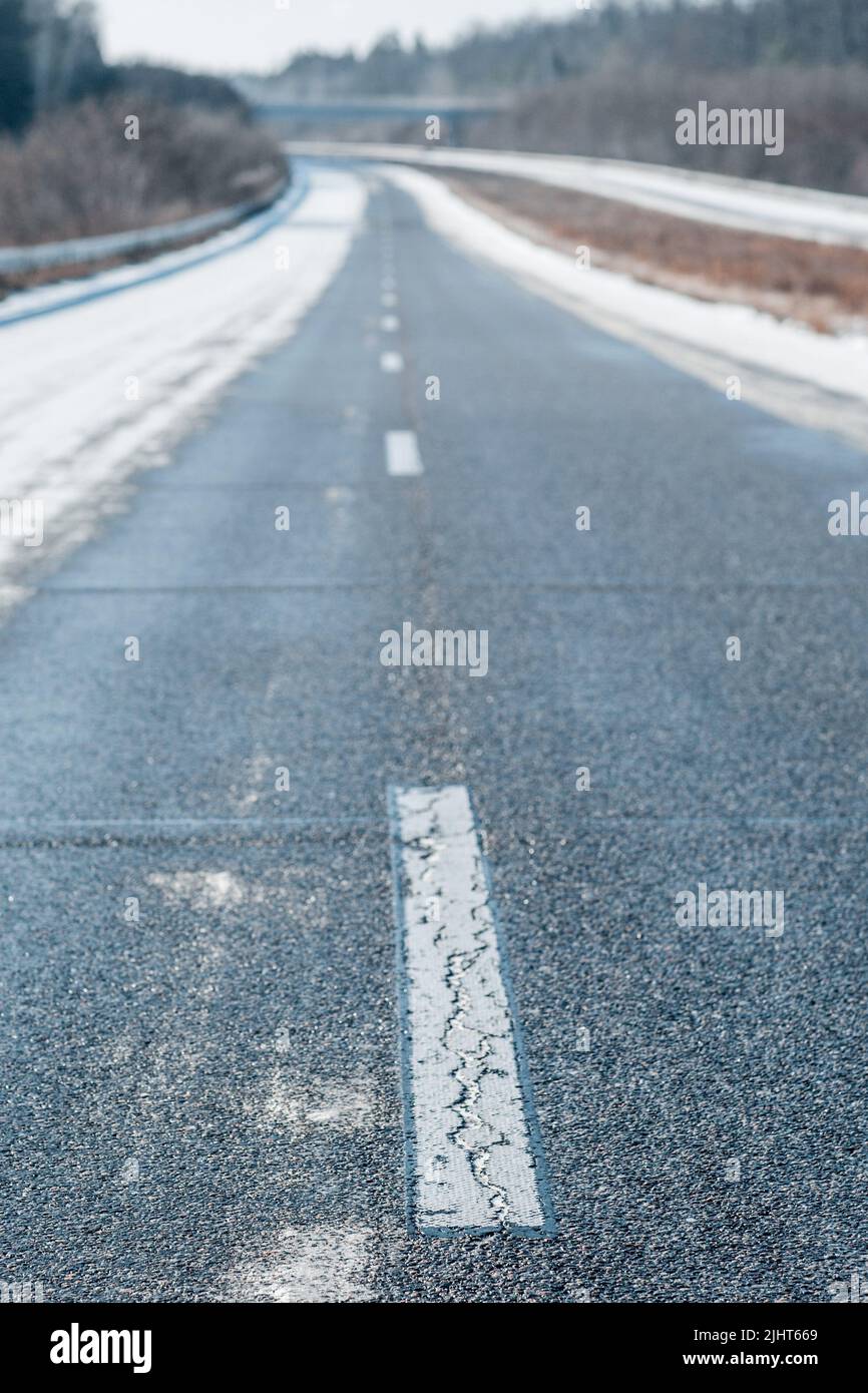 Winter empty highway with a dashed white line Stock Photo - Alamy