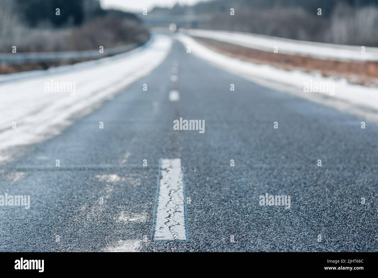 Winter empty highway with a dashed white line Stock Photo - Alamy