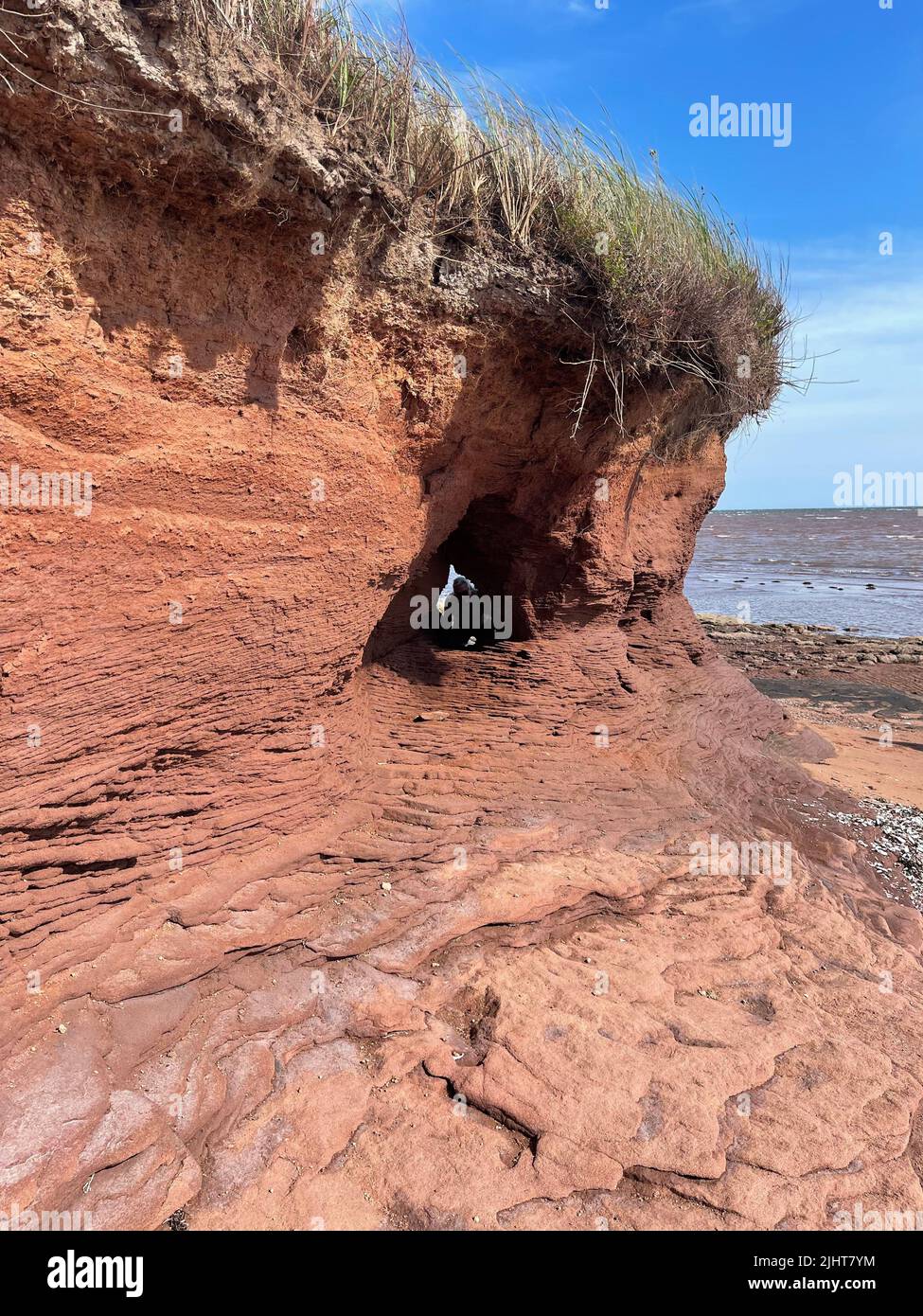 The red sand rock cliff erosion view of the shore of Prince Edward ...