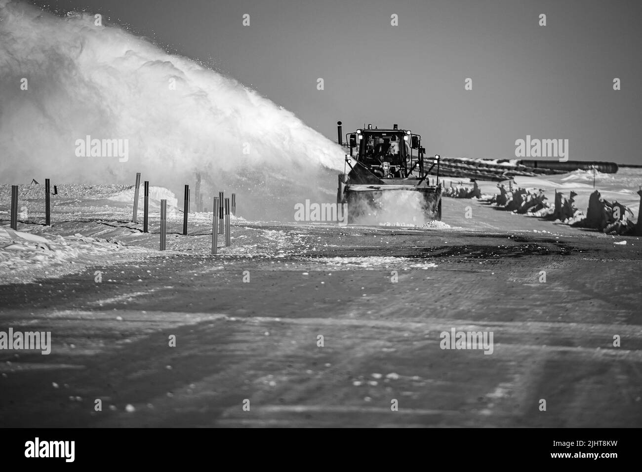 A grayscale of a Tractor clearing the snow Stock Photo - Alamy