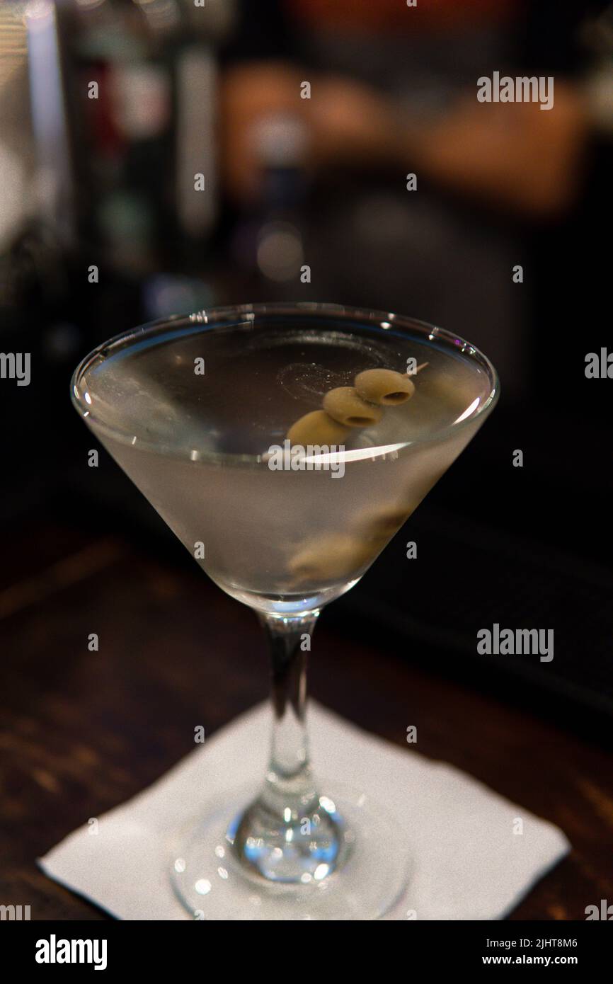 Close-up of a freshly prepared martini sitting on a bar counter ...