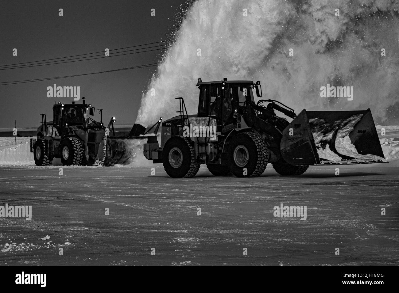 A grayscale of Tractors clearing the snow Stock Photo - Alamy