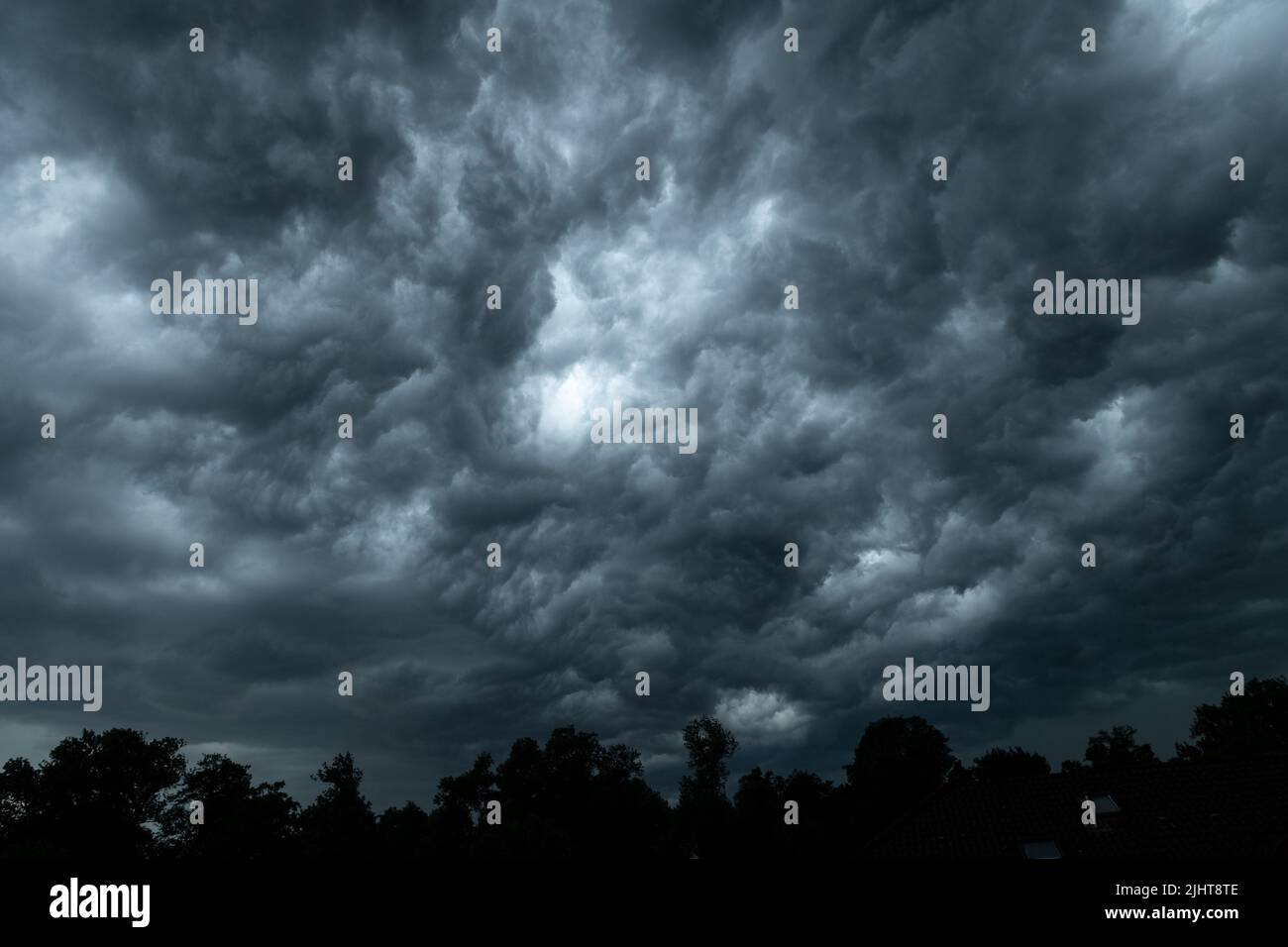 Dramatic dark clouds short before a thunderstorm and heavy rain over ...