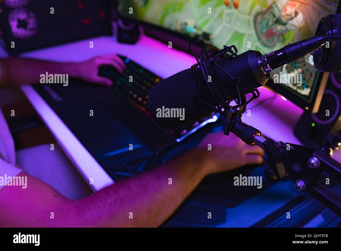 A closeup of hands on a mouse and keyboard playing a game on a PC in a ...
