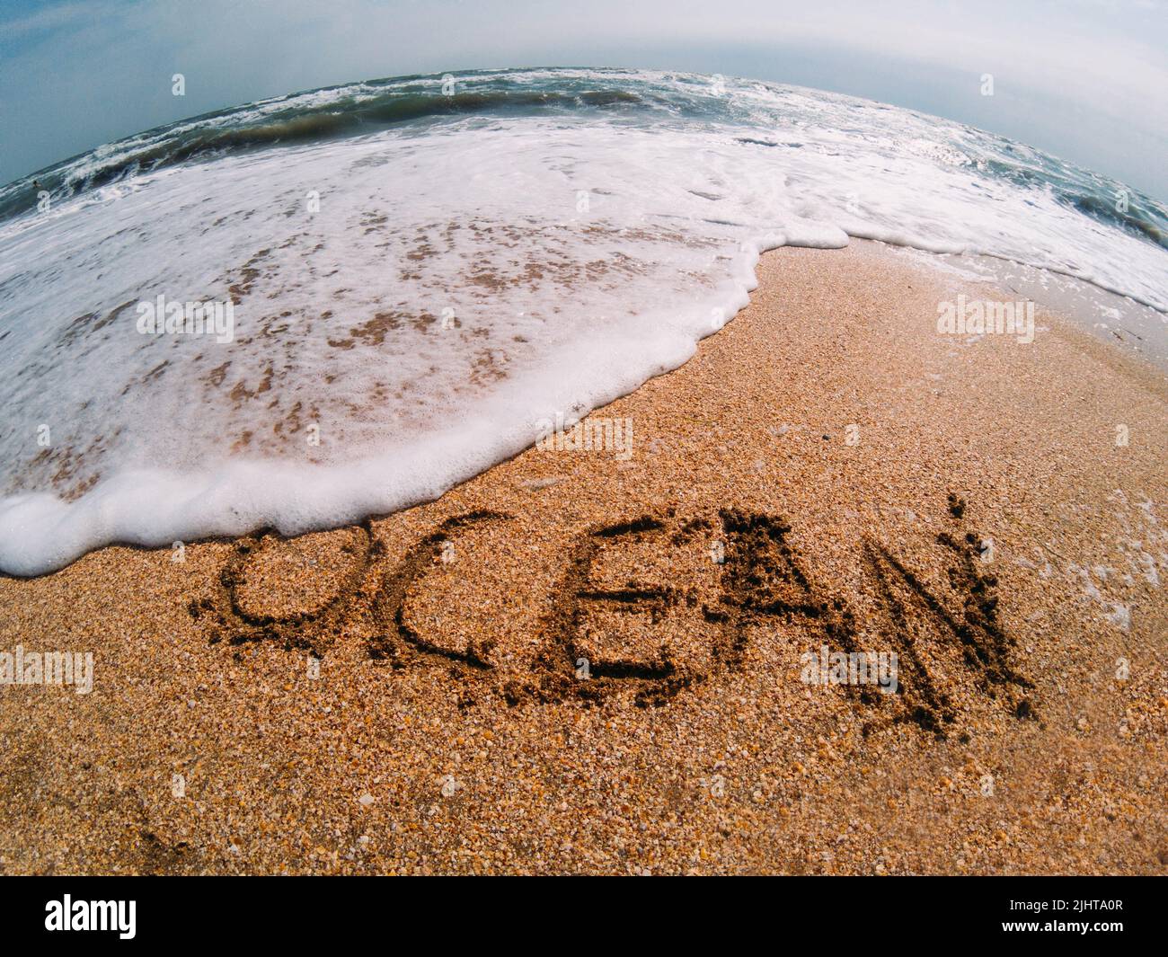 travel tourism seaside summer ocean tide sand word Stock Photo - Alamy
