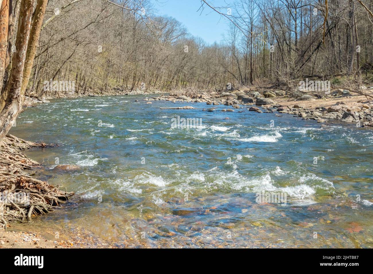 A scenic view of a river flowing over the rocks in Patapsco State Park ...