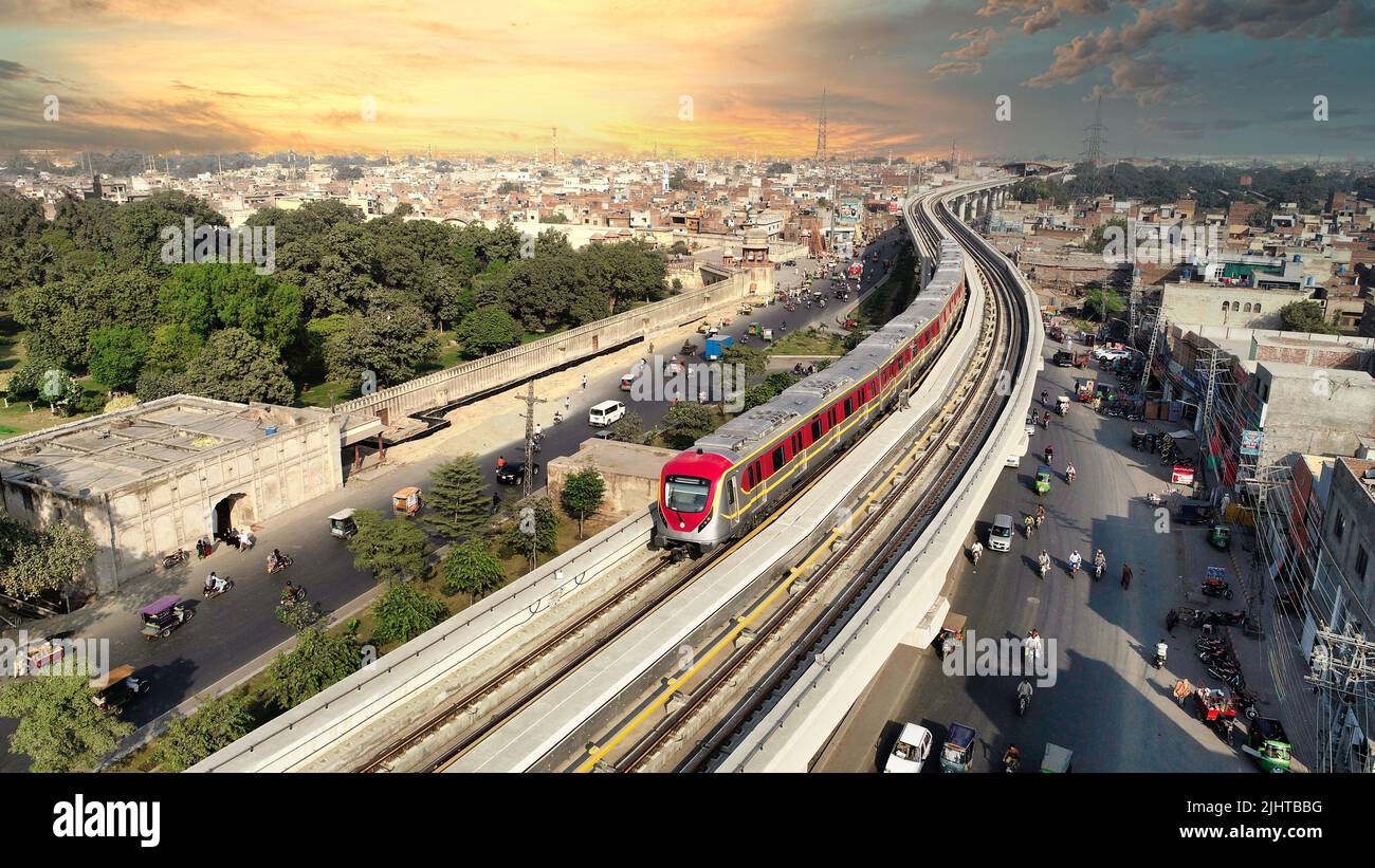 An aerial shot of a train passing through a town with a beautiful ...