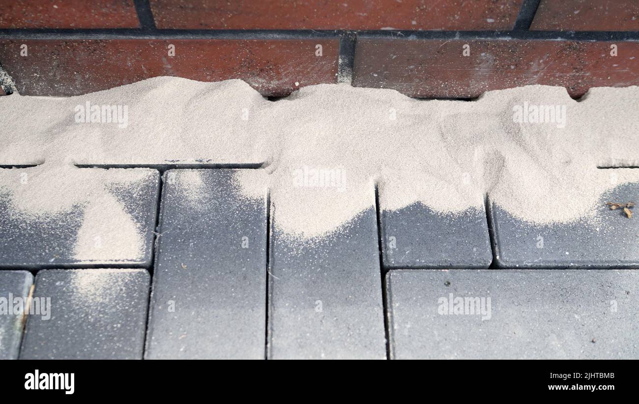 A close-up of a ladle in the hands of a man who throws it into the ...