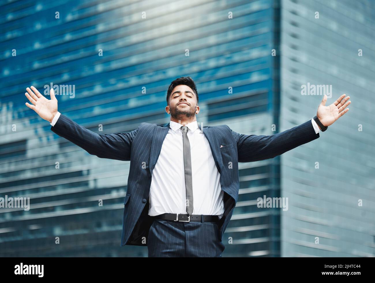 Reaching out and grabbing success. a handsome young businessman ...