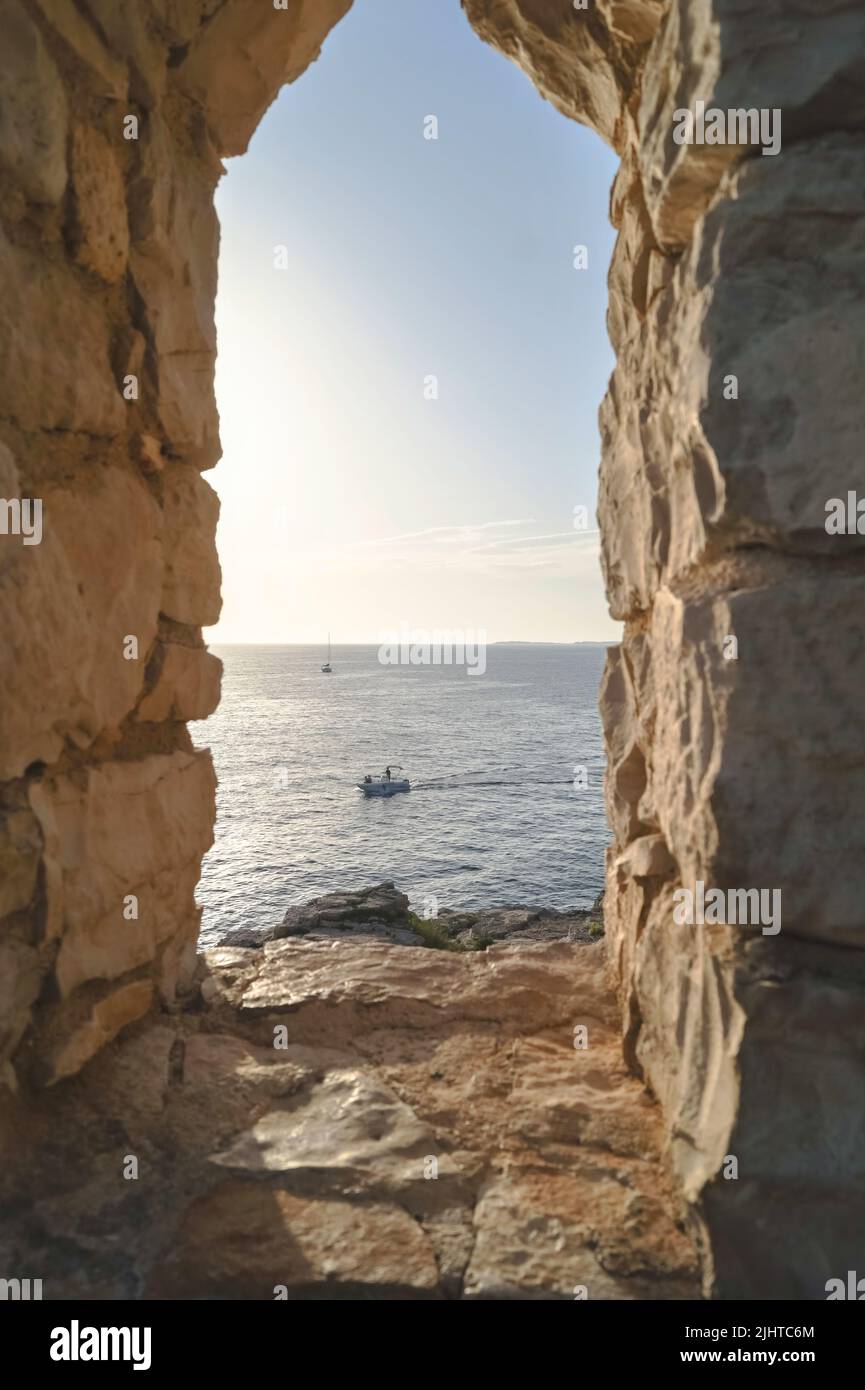 Landscape on the rocky shore of the Adriatic through the window on the ...