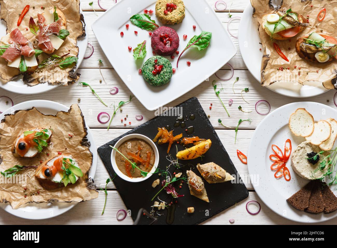 Dinner table with different appetizers Stock Photo - Alamy